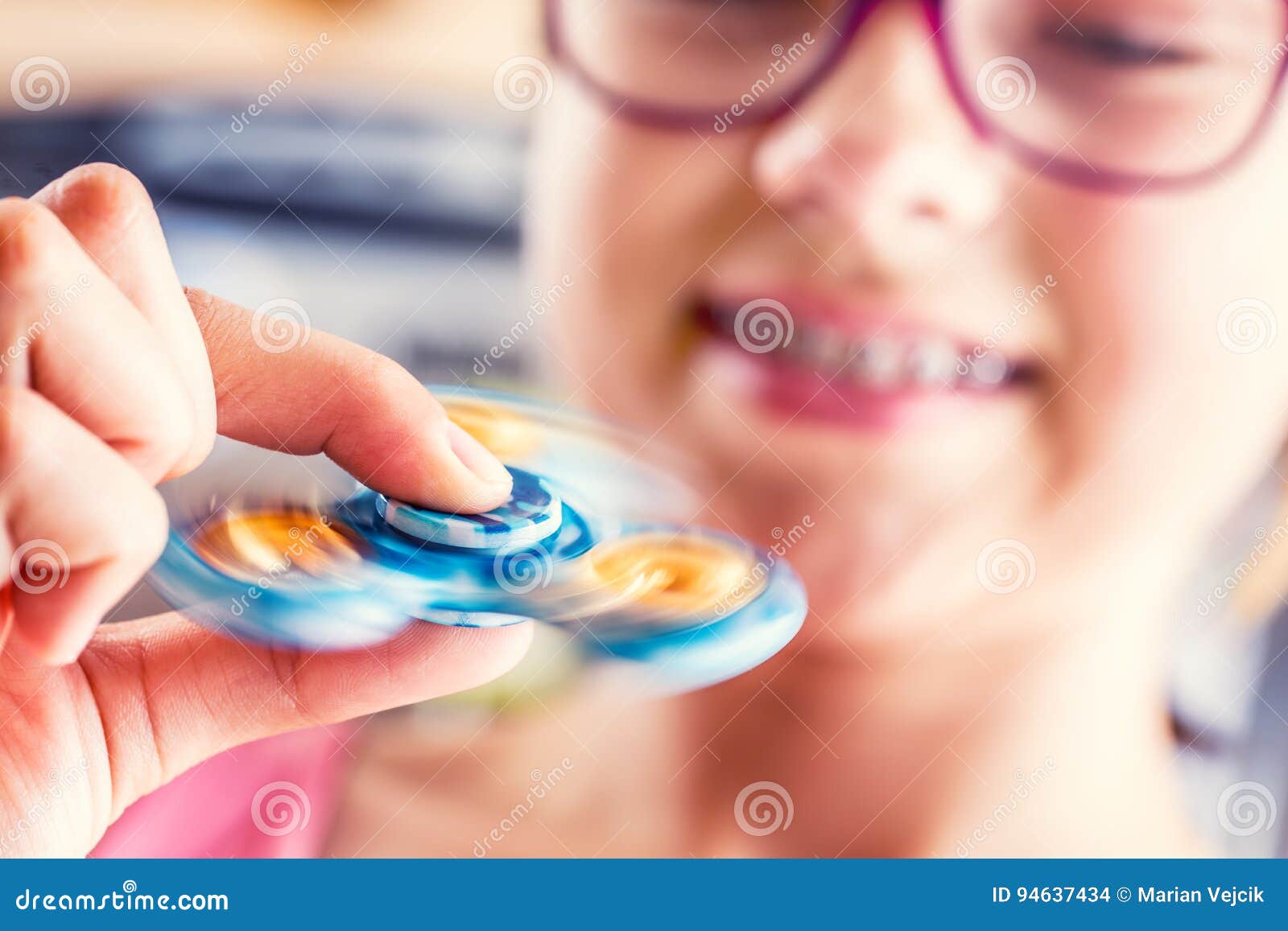 Fidget Spinner. Cute Young Girl Playing with Fidget Spinner Stock Photo ...
