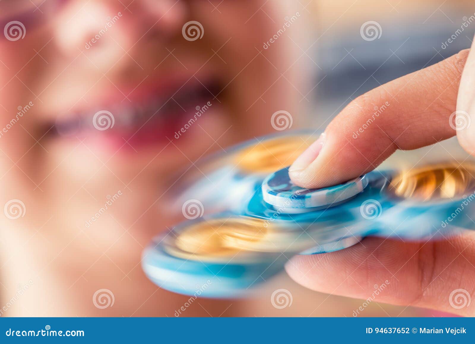 Fidget Spinner. Cute Young Girl Playing with Fidget Spinner Stock Photo ...