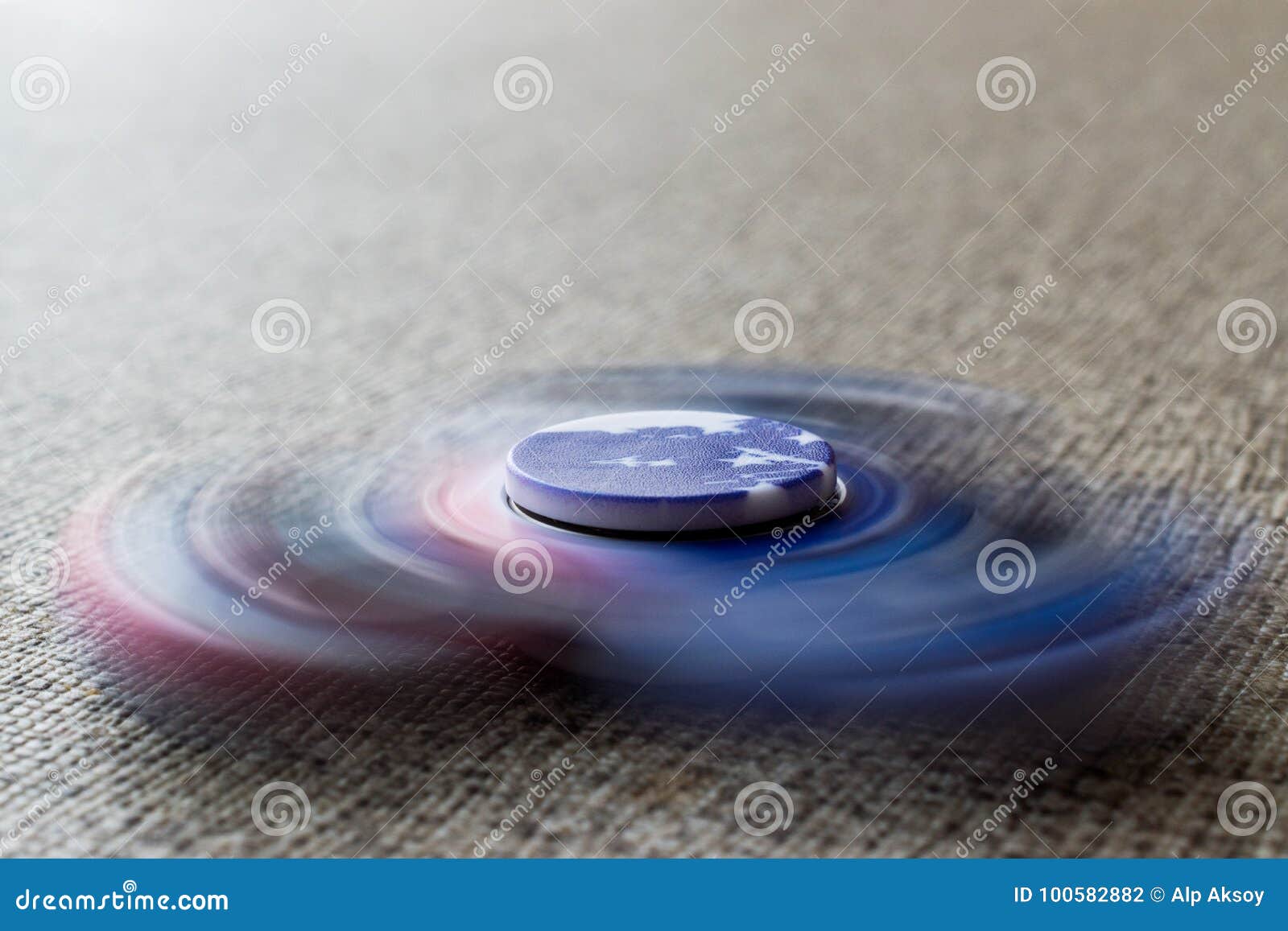 Fidget Spinner on a Grey Surface. Stock Photo - Image of finger, cookie ...