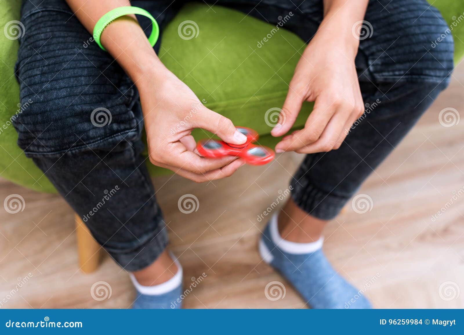 Fidget Spinner. Red Hand Spinner, Fidgeting Hand Toy Rotating on Child ... Fidget Spinner. Red Hand Spinner, Fidgeting Hand Toy Rotating on Child ...