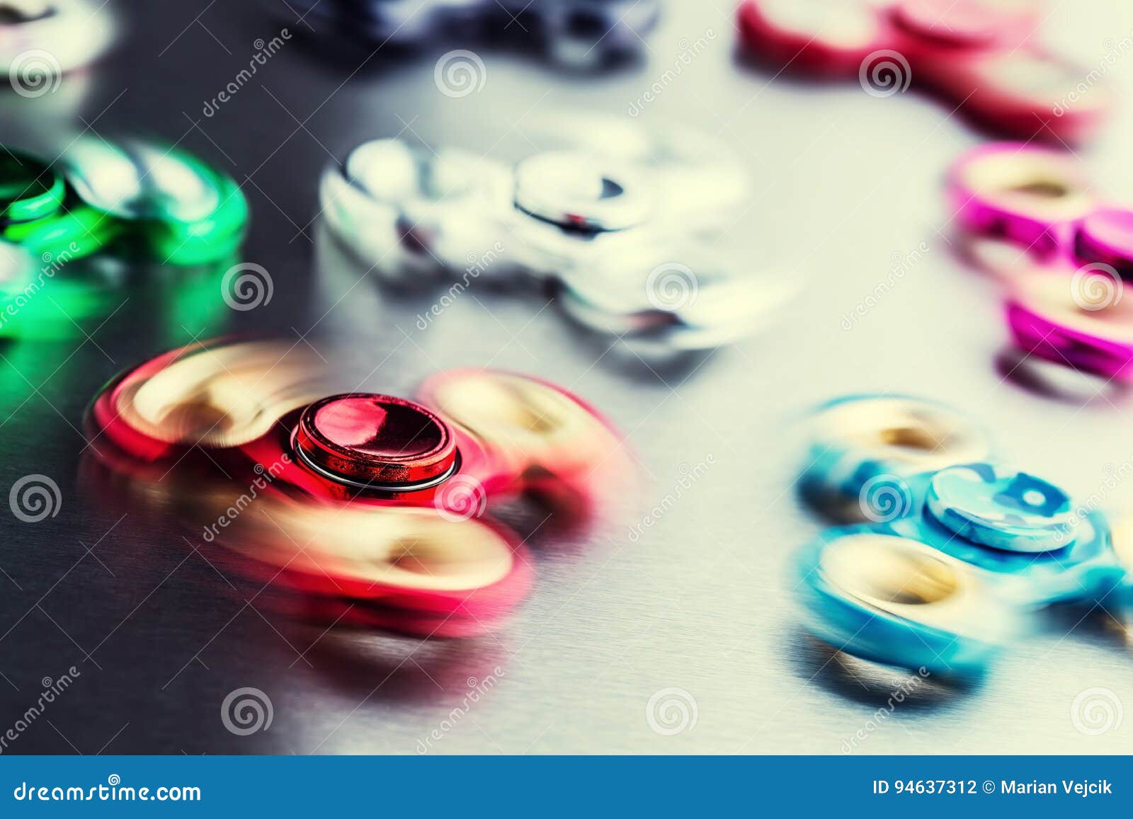 Fidget Spinner. Several Colorful Fidget Spinners on a Stainless Steel ...