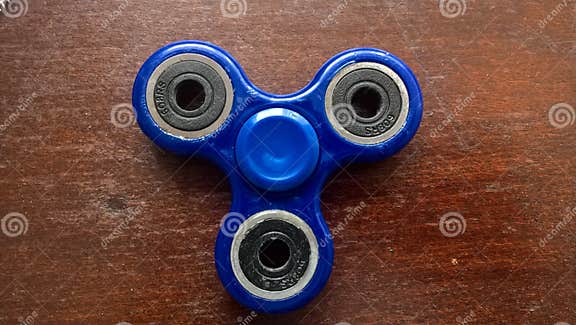 Fidget Spinner on a table stock image. Image of stress - 96323039