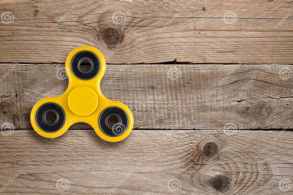 Fidget Spinner Toy on Table Stock Photo - Image of bearing, yellow ...