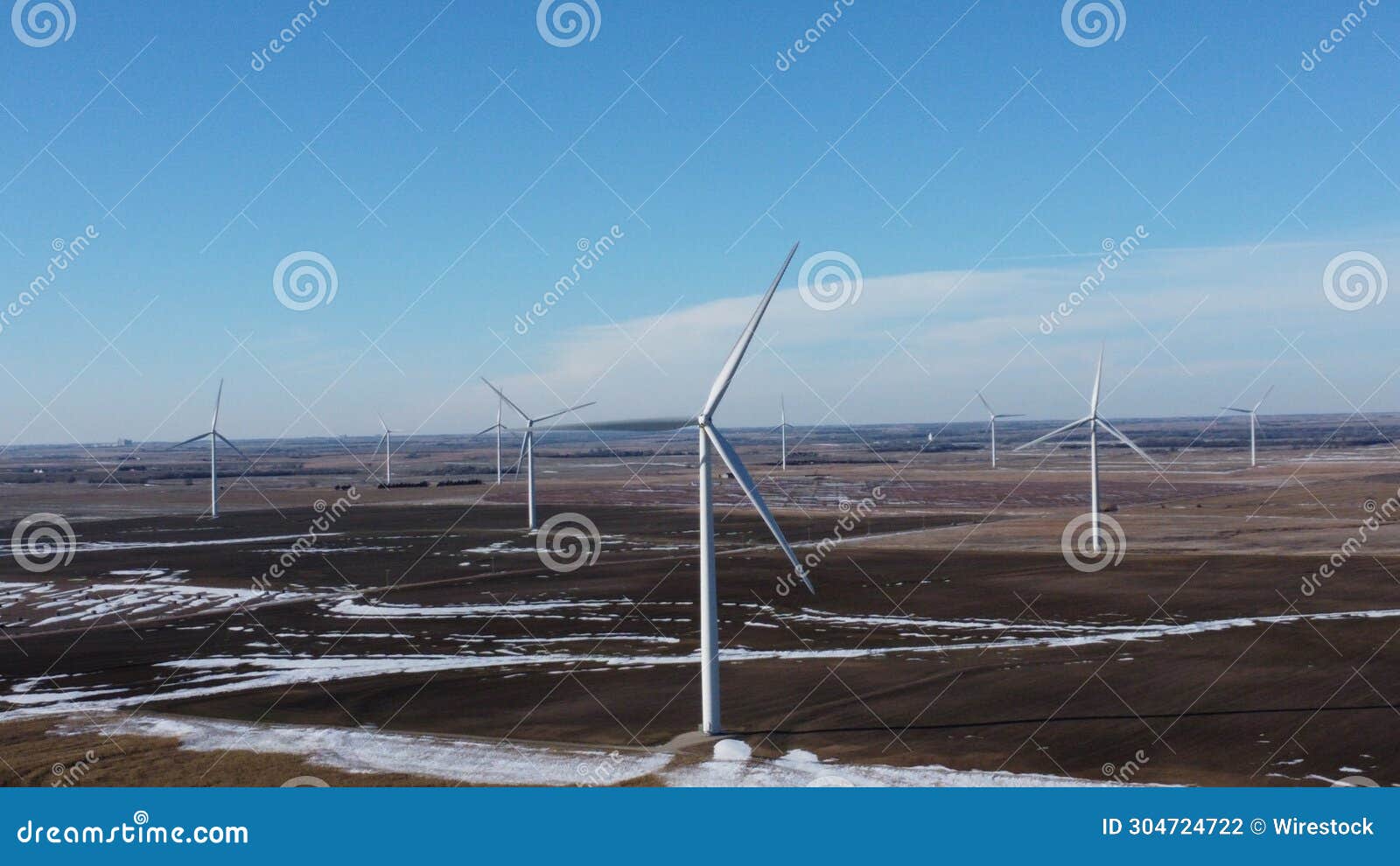 A Field Full of Wind Turbines in the Snow on a Sunny Day Stock Photo ...
