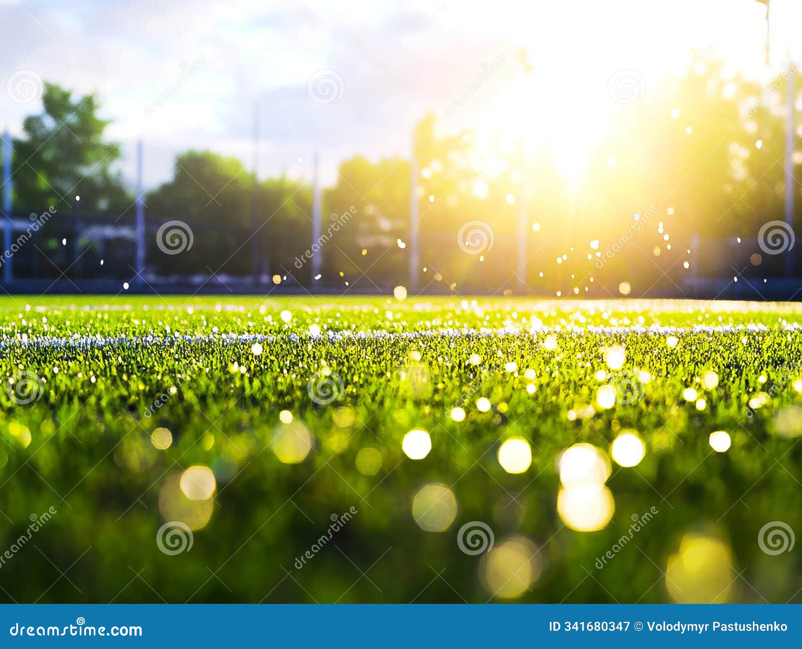 A Field of Green Grass with the Sun Shining through the Clouds Stock ...