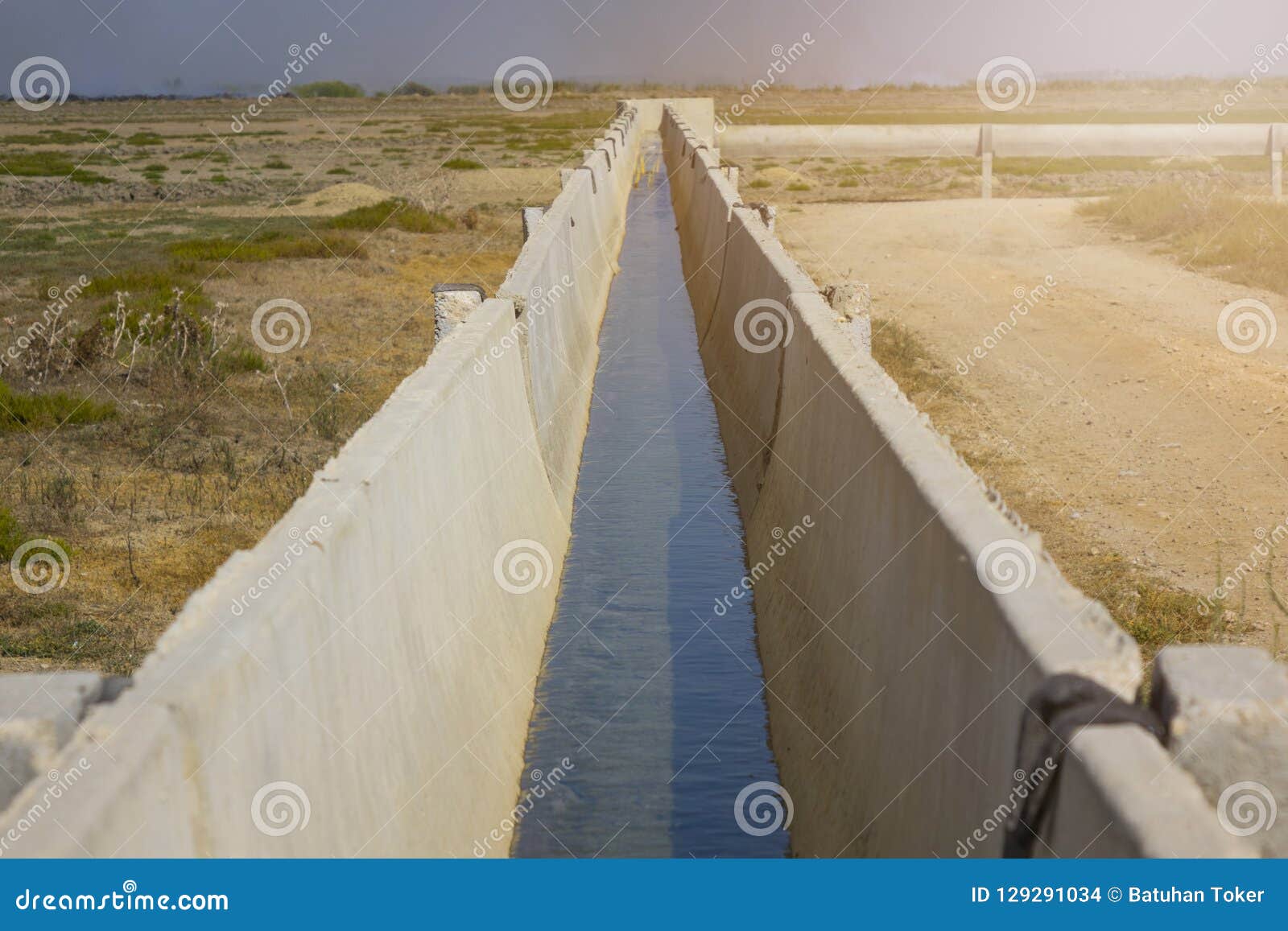 Water channel in the field stock photo. Image of beauty - 129291034