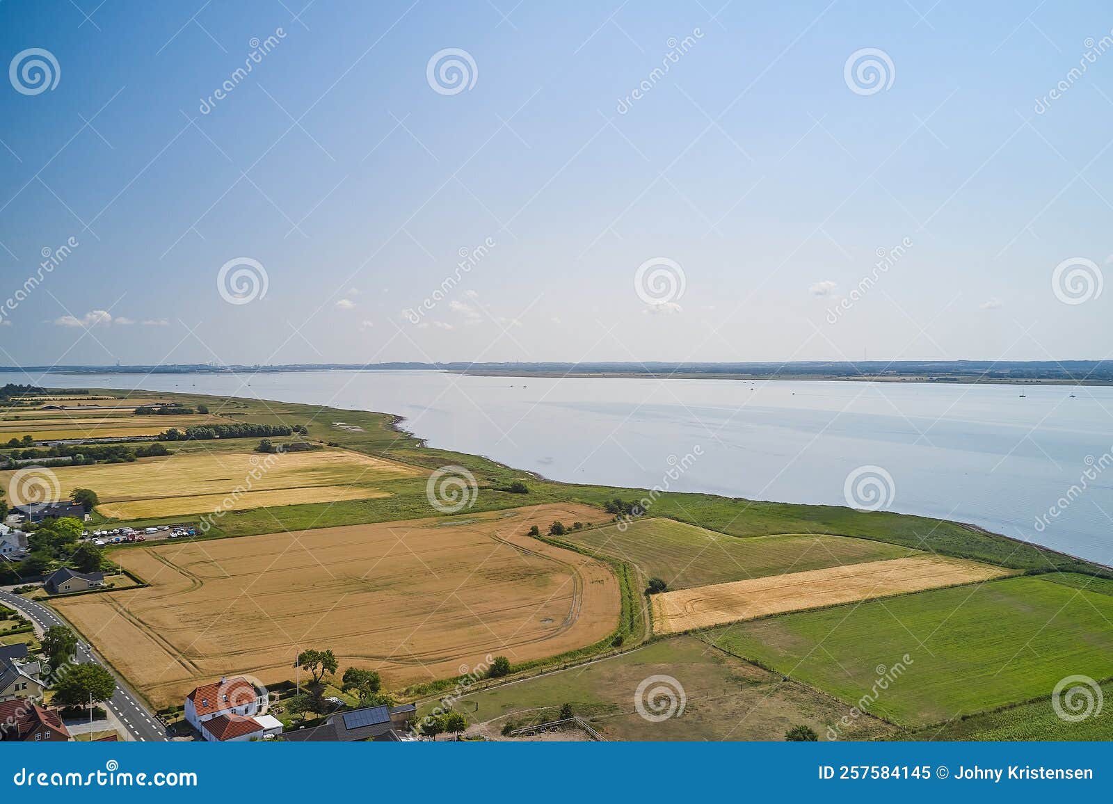 Field and the ocean view stock image. Image of sunset - 257584145