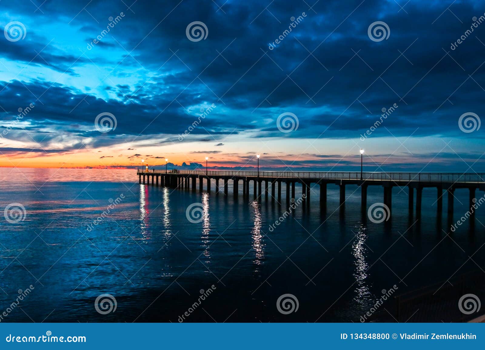 Fiery Cloud and Sky Over the Sea at Sunset with a Pier Stock Photo ...