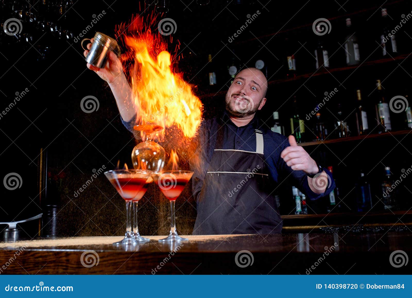 Fiery Show at the Bar. the Bartender Makes Hot Alcoholic Cocktail and ...