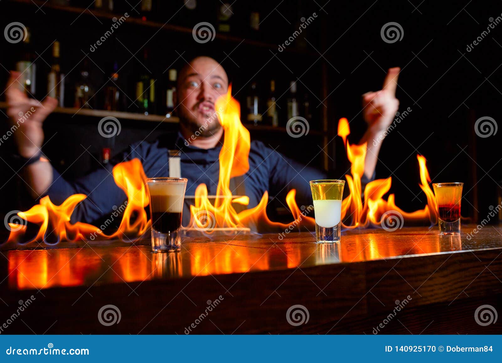 Fiery Show at the Bar. the Bartender Makes Hot Alcoholic Cocktail and ...