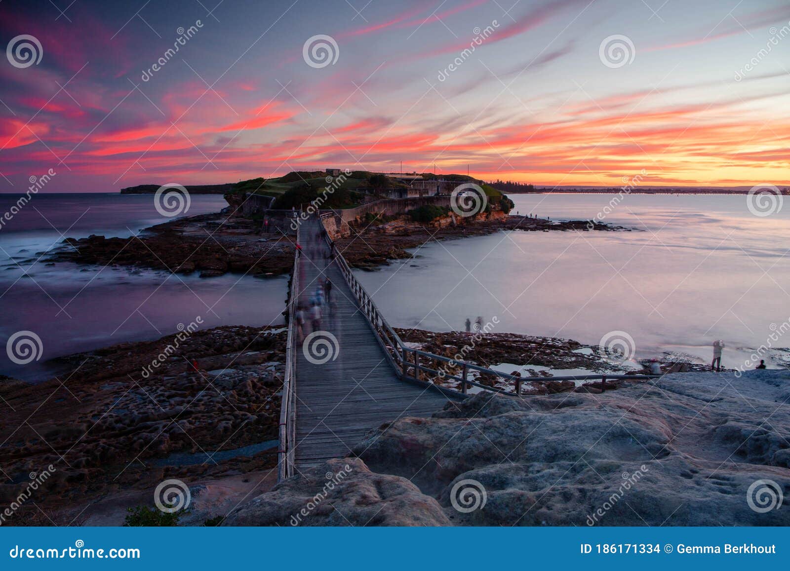 Fiery sunset over island stock photo. Image of dawn - 186171334