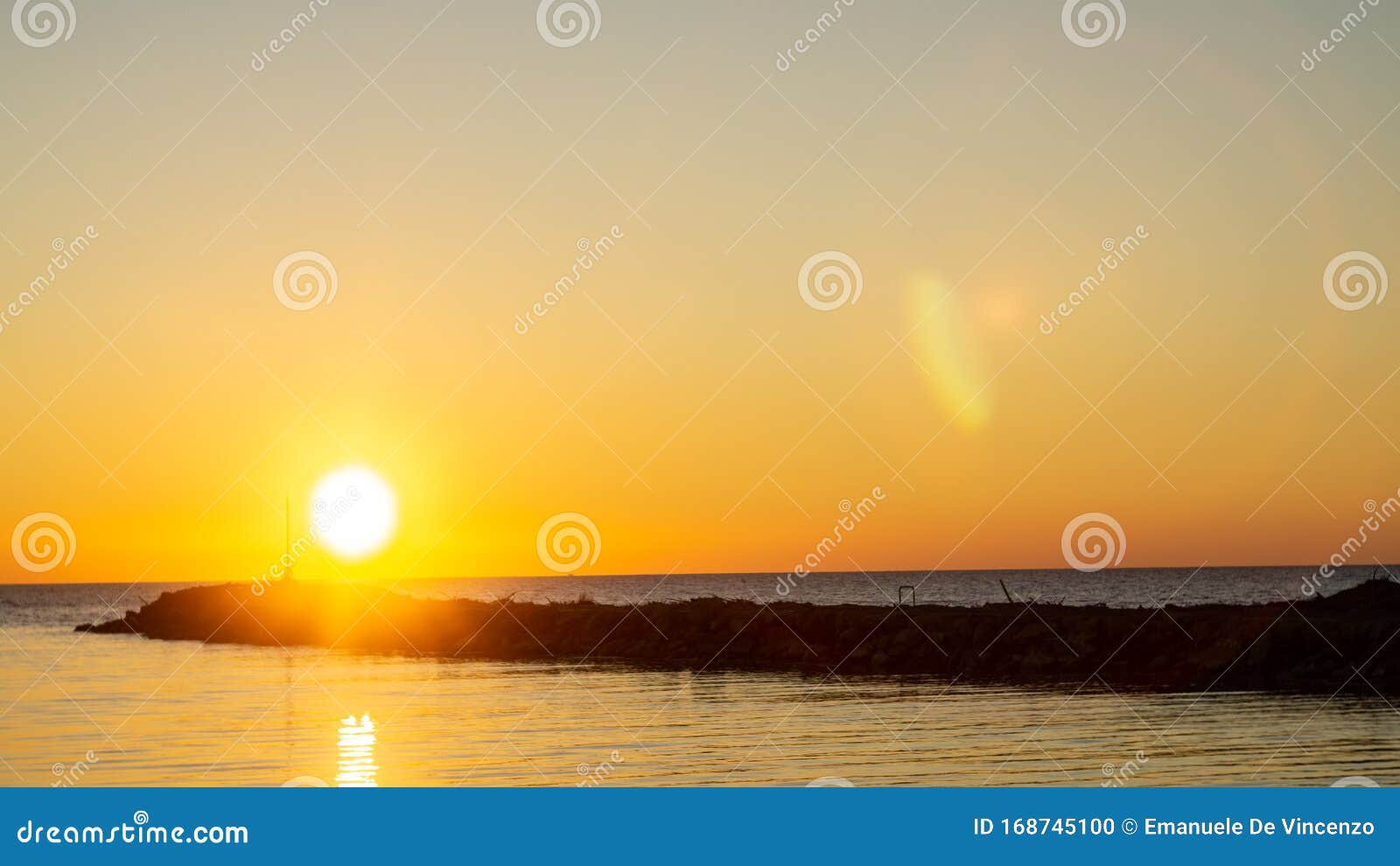 Fiery Sunset Over the Sea with Pier Stock Photo - Image of sunset, pier ...
