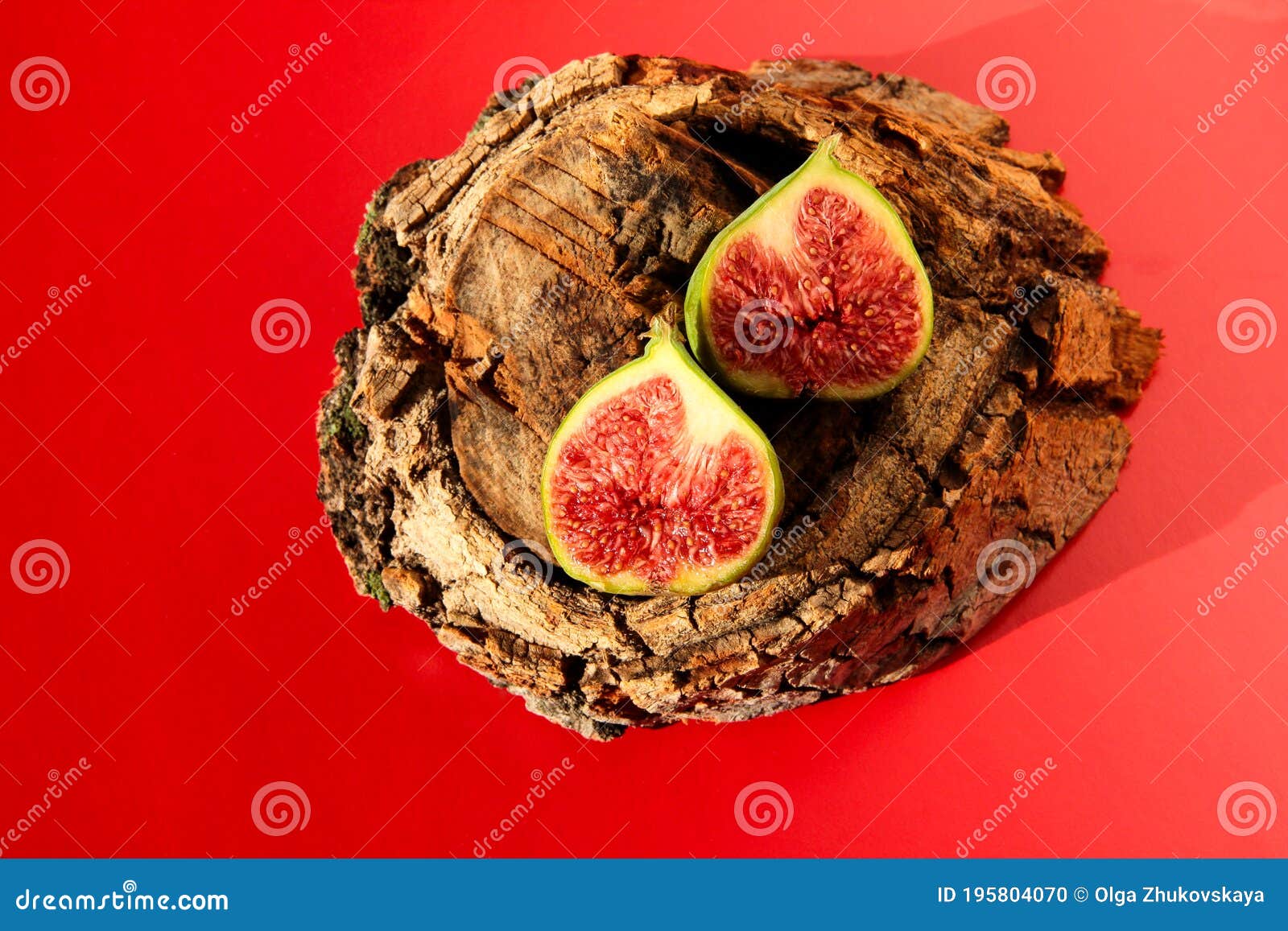 Fig Pieces on a Wooden Stump. Figs on a Red Background Stock Photo ...