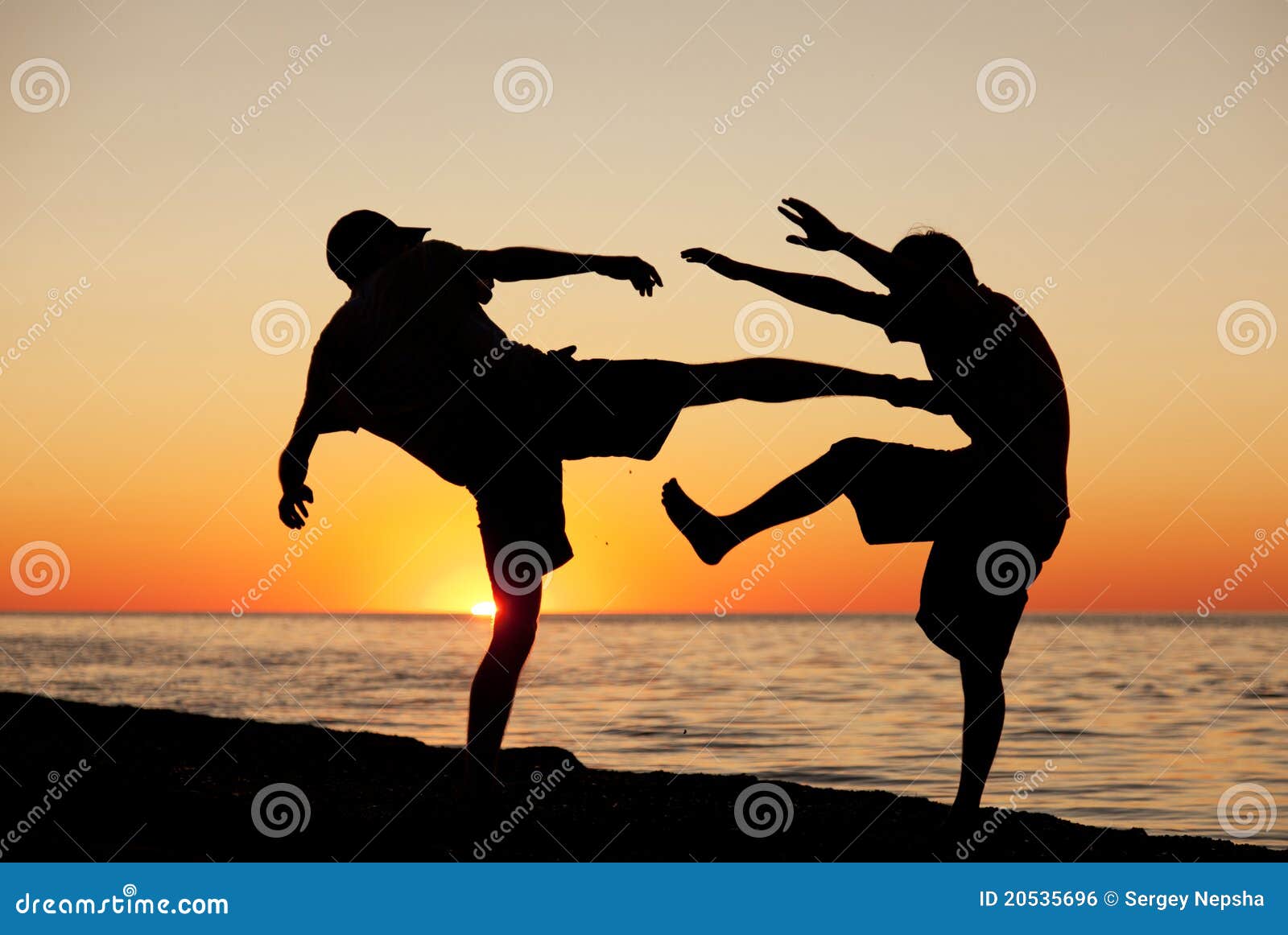 Fight on a beach stock photo. Image of sunset, shadow - 20535696