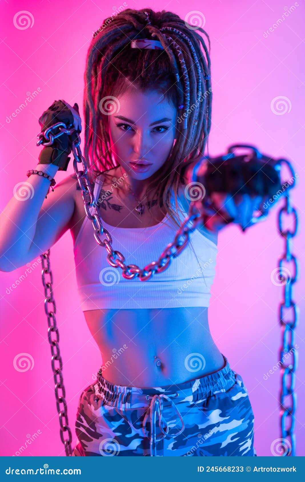 A Fighter Girl with Chains on Her Hands with Beautiful Dreadlocks on ...