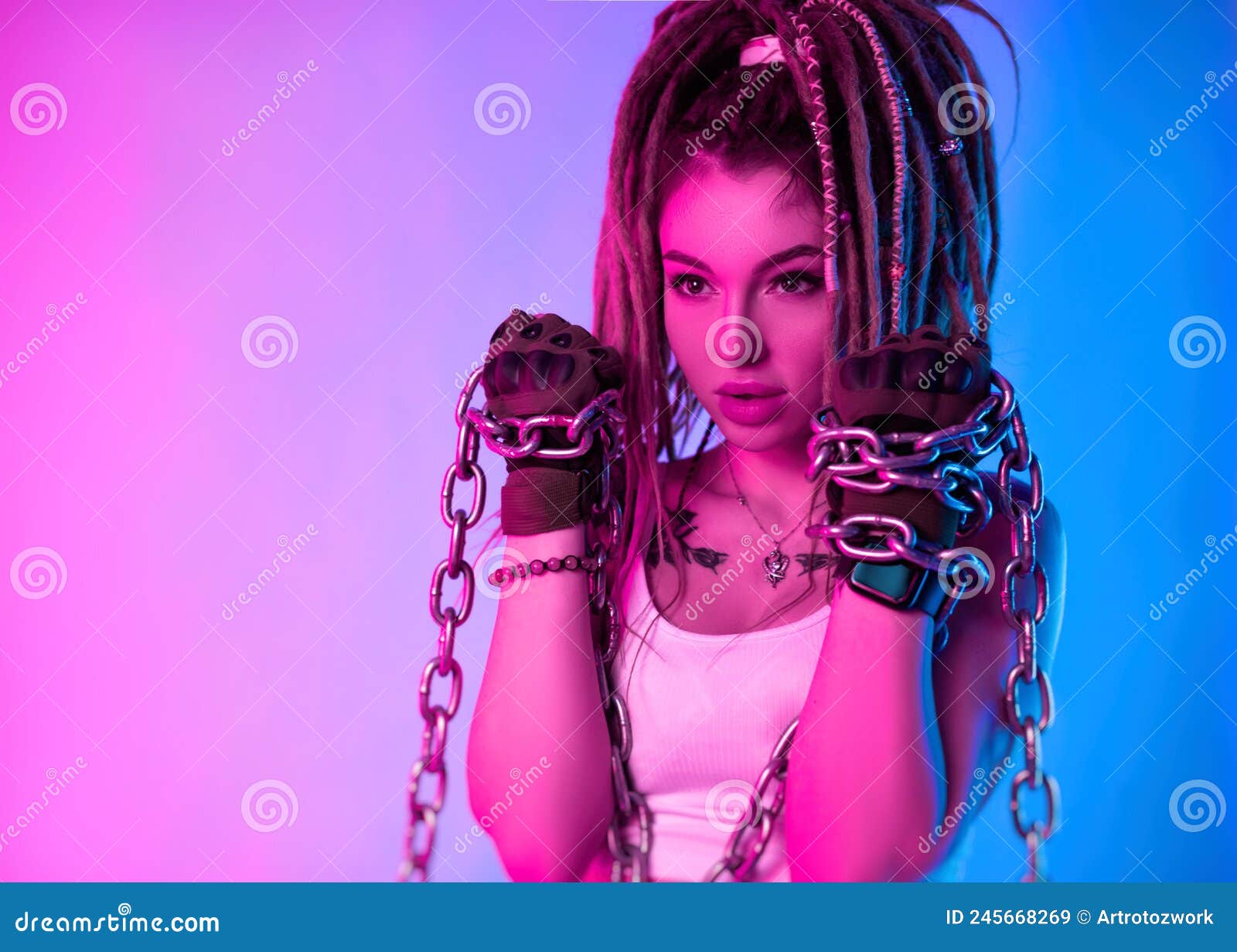 A Fighter Girl with Chains on Her Hands with Beautiful Dreadlocks on ...