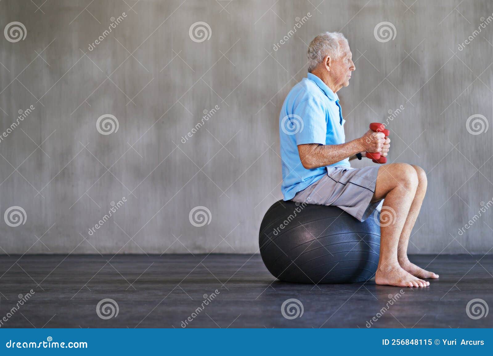 Fighting Against Aging. an Elderly Man Using Weights while Sitting on a ...