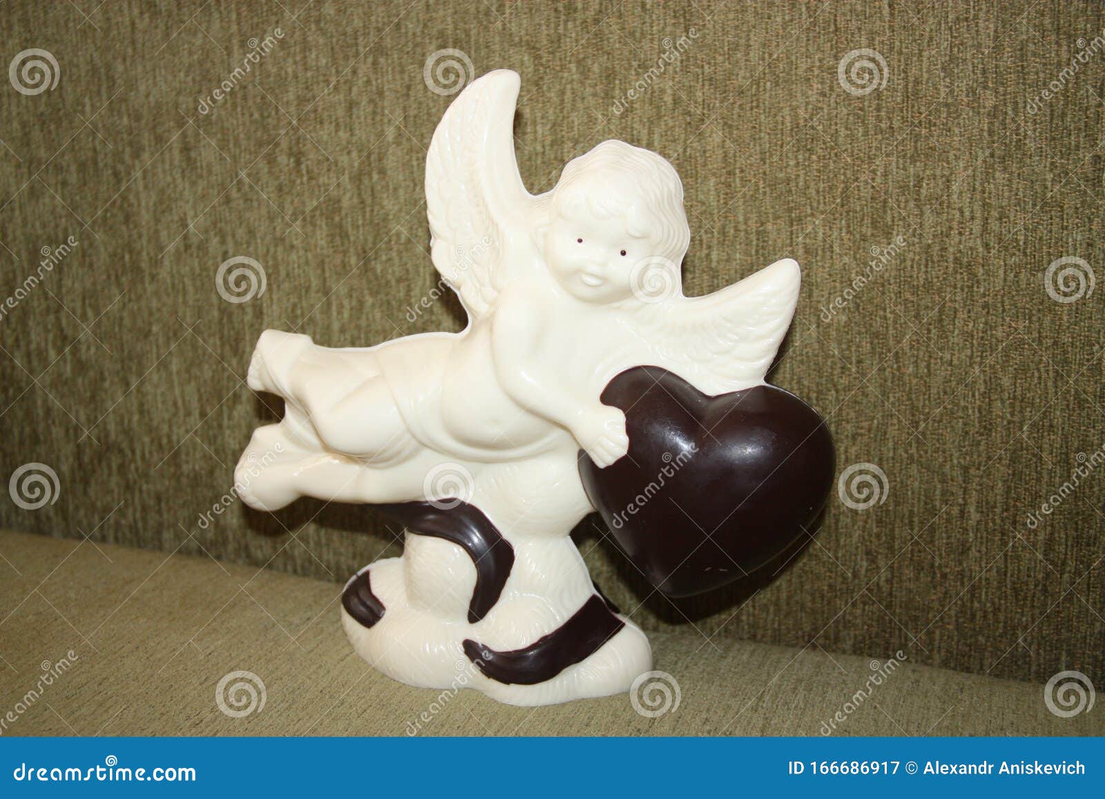The Figure of an Angel with a Heart in His Hands. Stock Image - Image ...