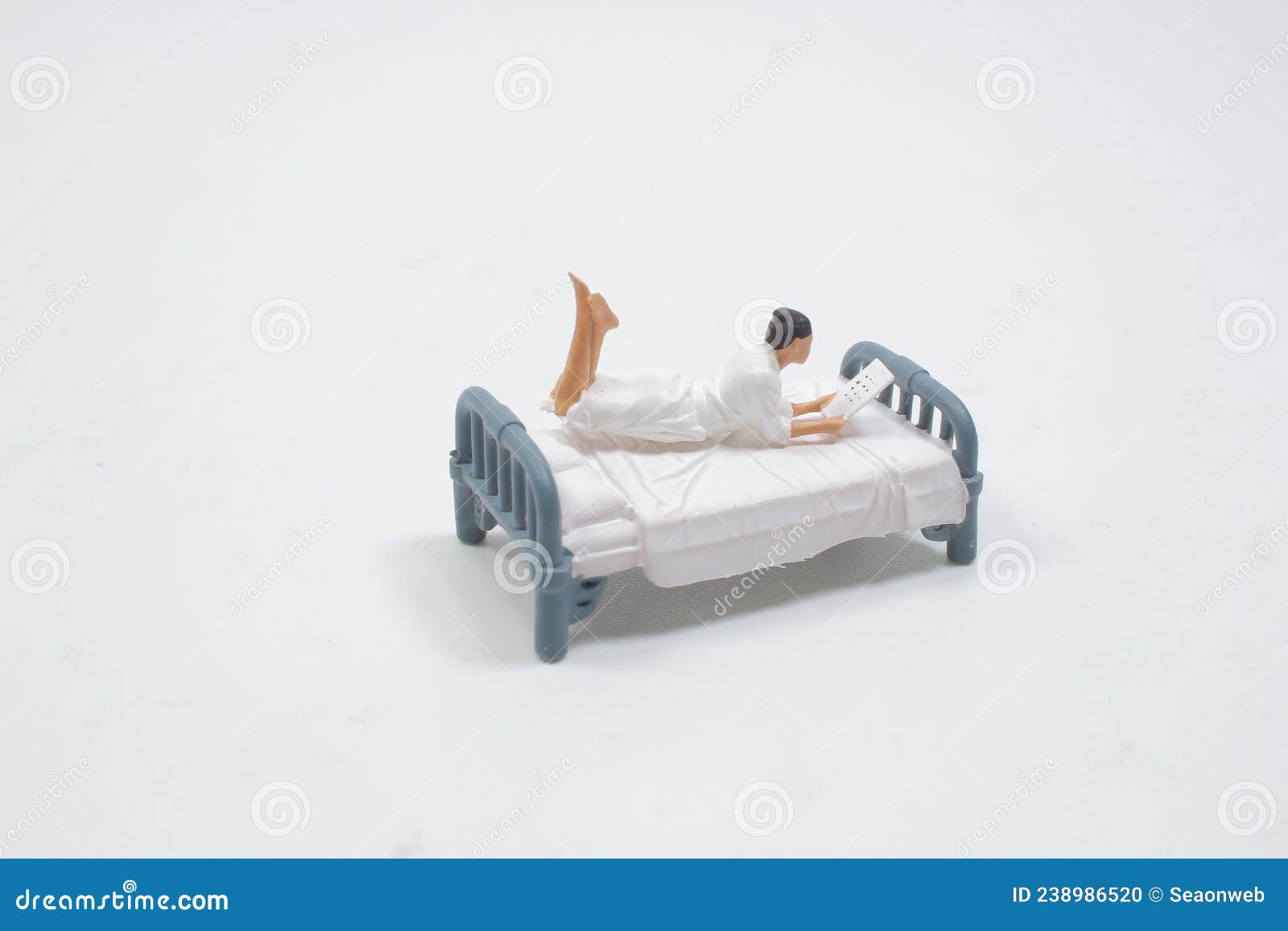 A Figure Laying on Holding Book Isolated on White Stock Photo - Image ...