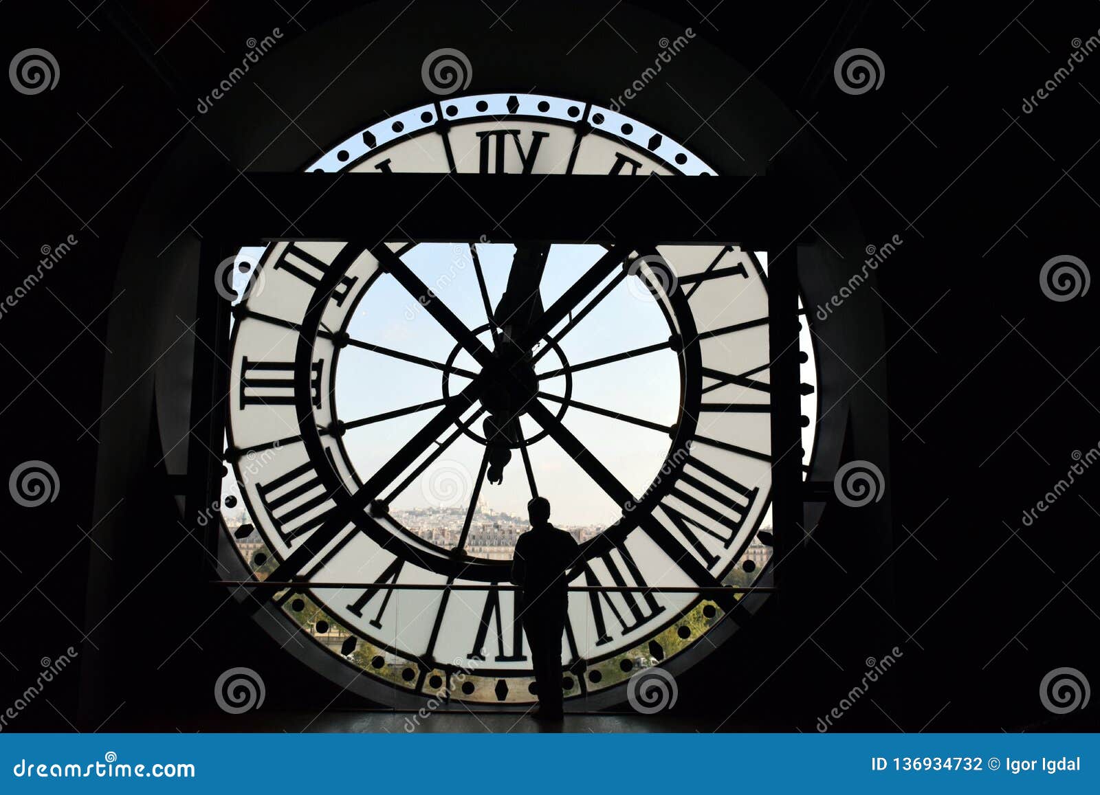 The Figure of a Man Against the Backdrop of a Huge Wall Clock Stock ...