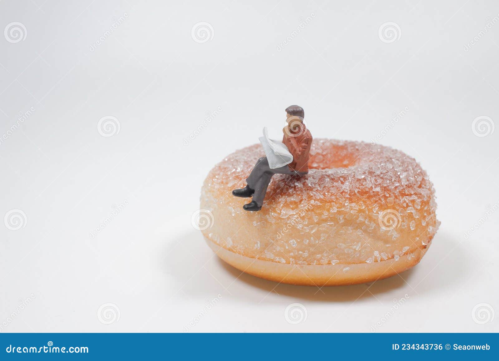 A Figure Man Sit Onm the Big Donut Top Read Newspaper Stock Photo ...