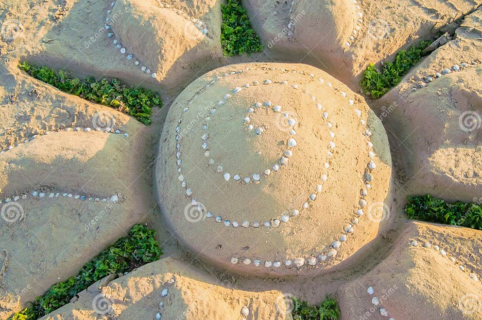 The Figure of the Sun from the Sand on the Beach Stock Photo - Image of ...