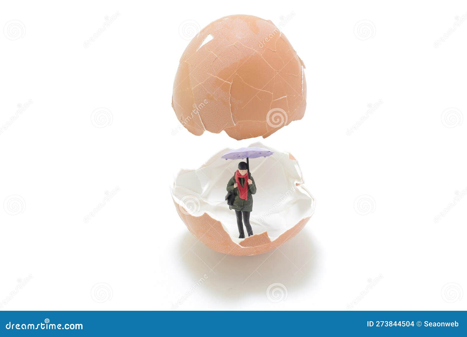 A Figure with an Umbrella Hatching Out of an Eggshell Stock Photo ...
