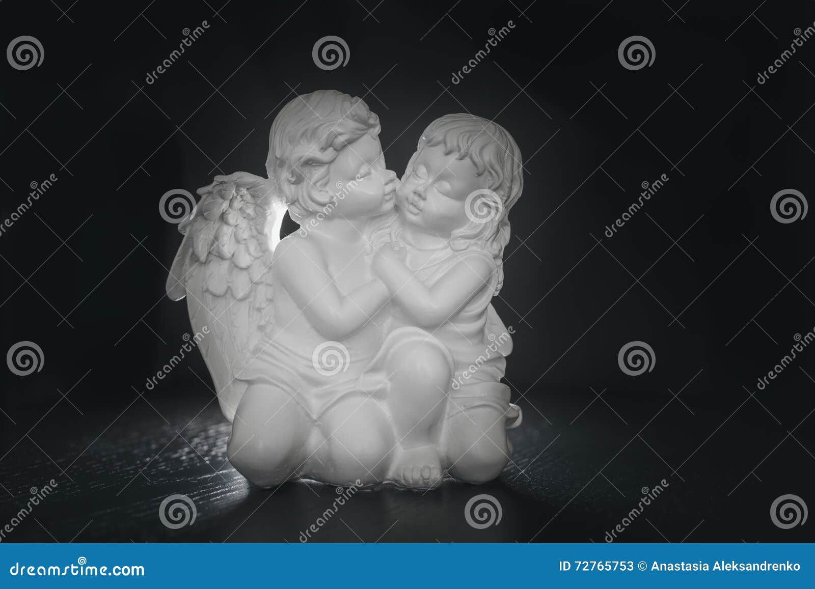 Figurine of Angels on a Black Background with Backlight Stock Image ...