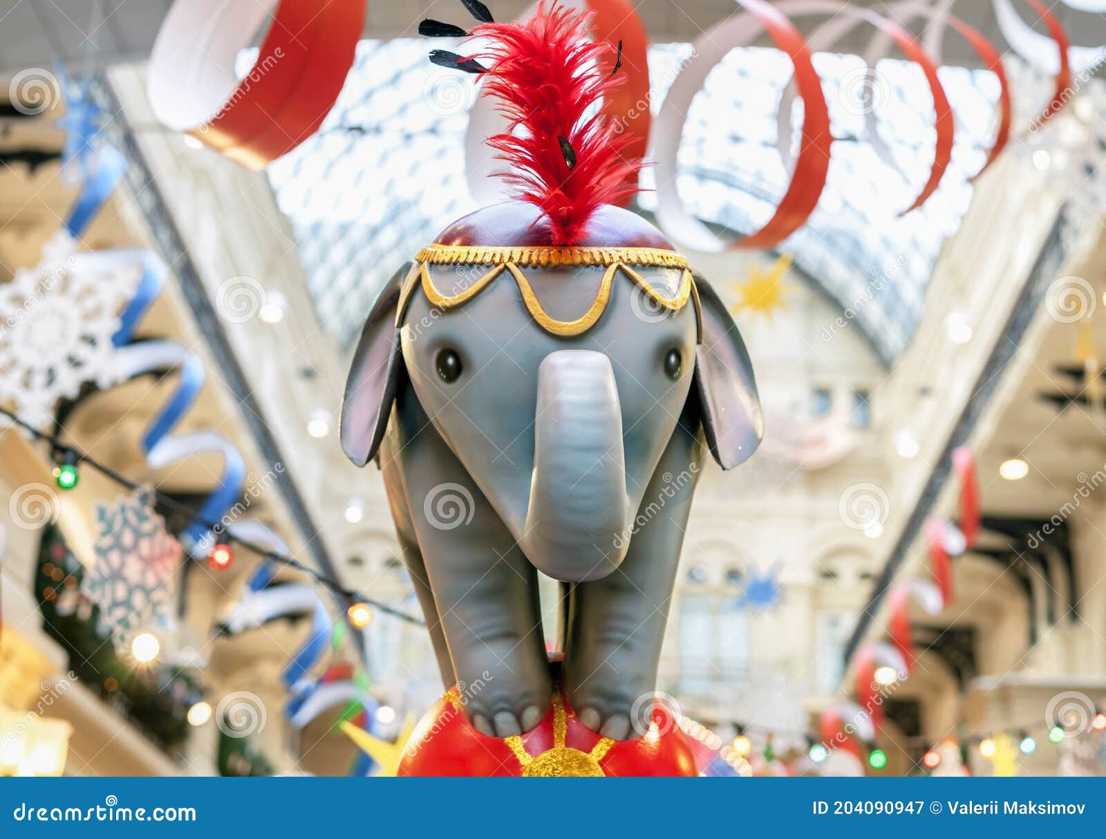 Figurine of a Circus Elephant with a Feather on Its Head and on a Red ...
