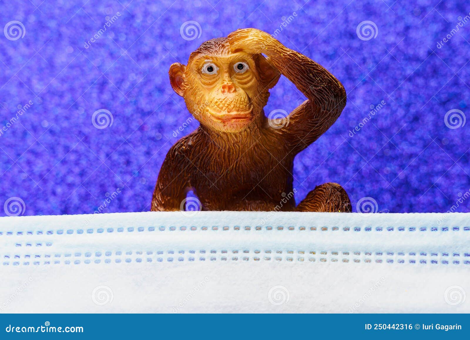 Figurine of a Monkey Behind a Medical Surgical Mask. the Concept of ...