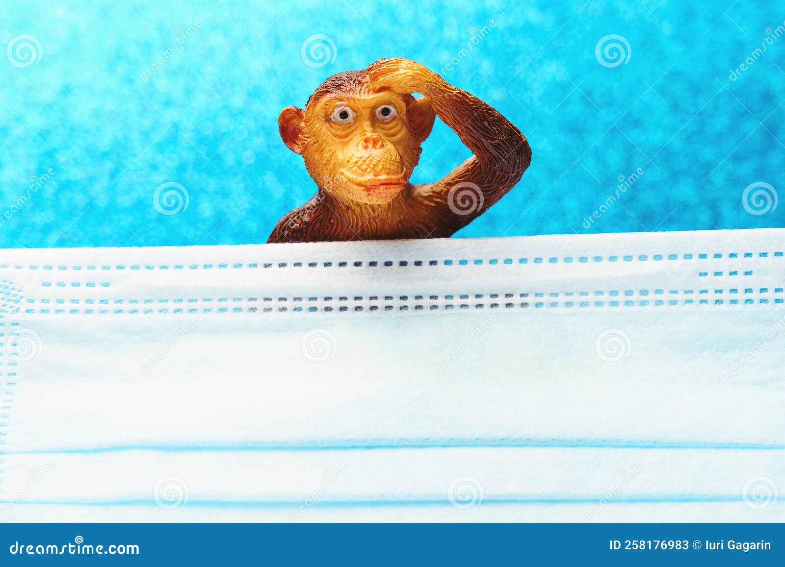 Figurine of a Monkey Behind a Medical Surgical Mask. the Concept of ...