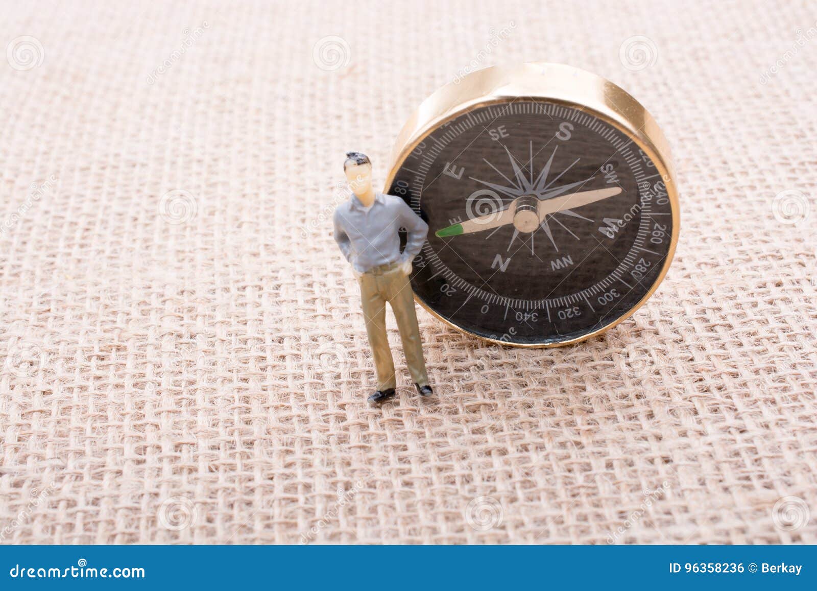 Figurine by the Side of a Compass Stock Photo - Image of nature ...