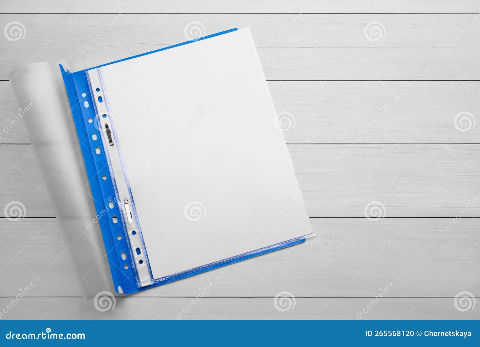 File Folder with Punched Pockets and Paper Sheets on White Wooden Table ...