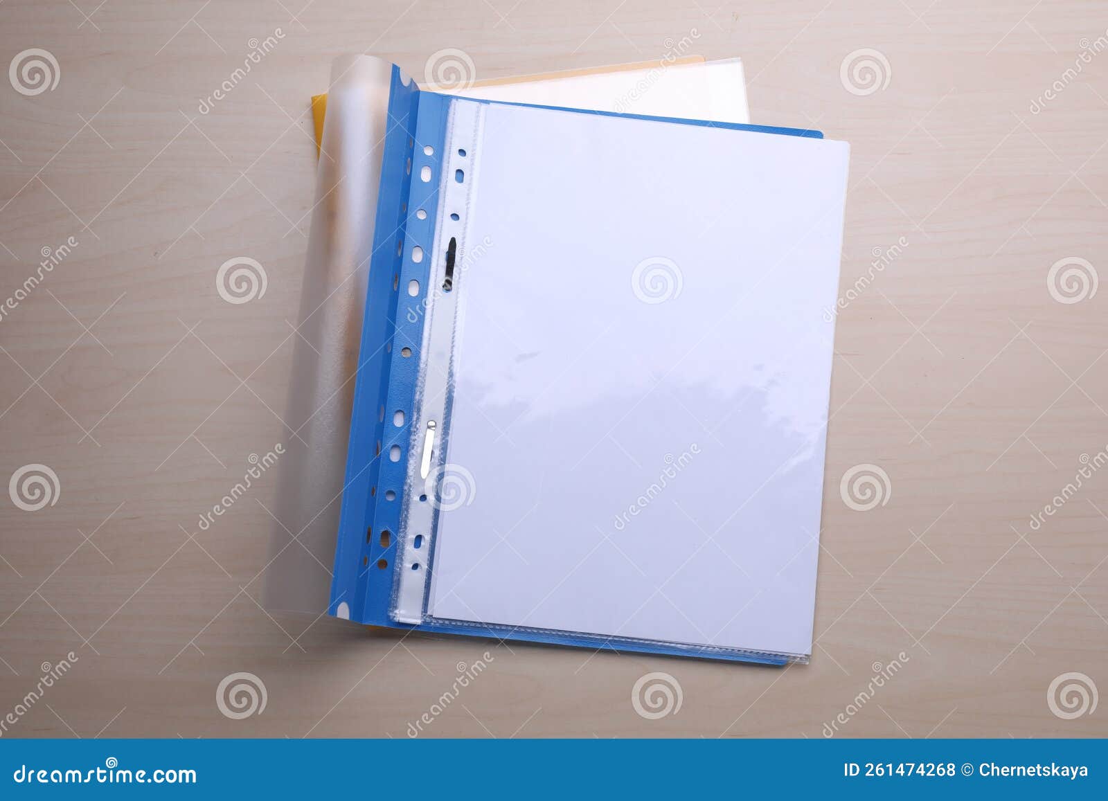 File Folder with Punched Pockets and Paper Sheets on Wooden Table, Top ...