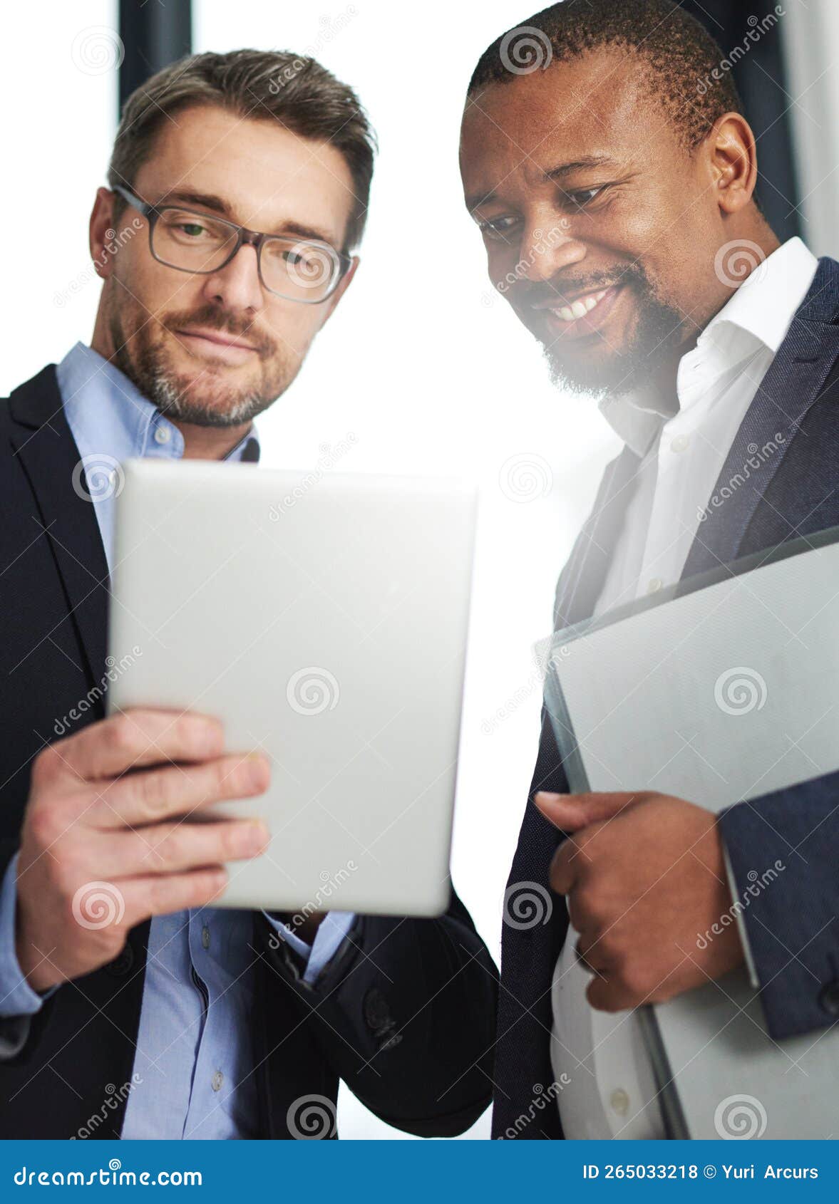 File Sharing Done in Real Time. Two Businessmen Using a Digital Tablet ...