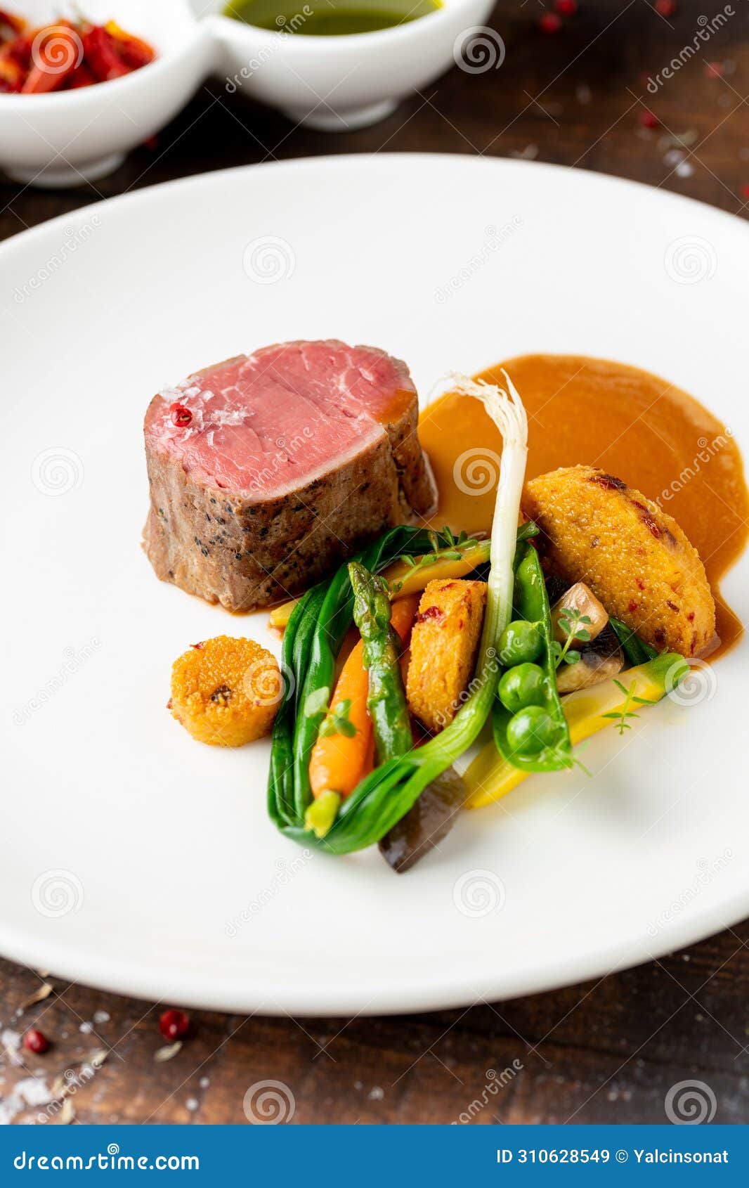 Filet Mignon Served with Vegetables and Sauces at a Fine Dining ...