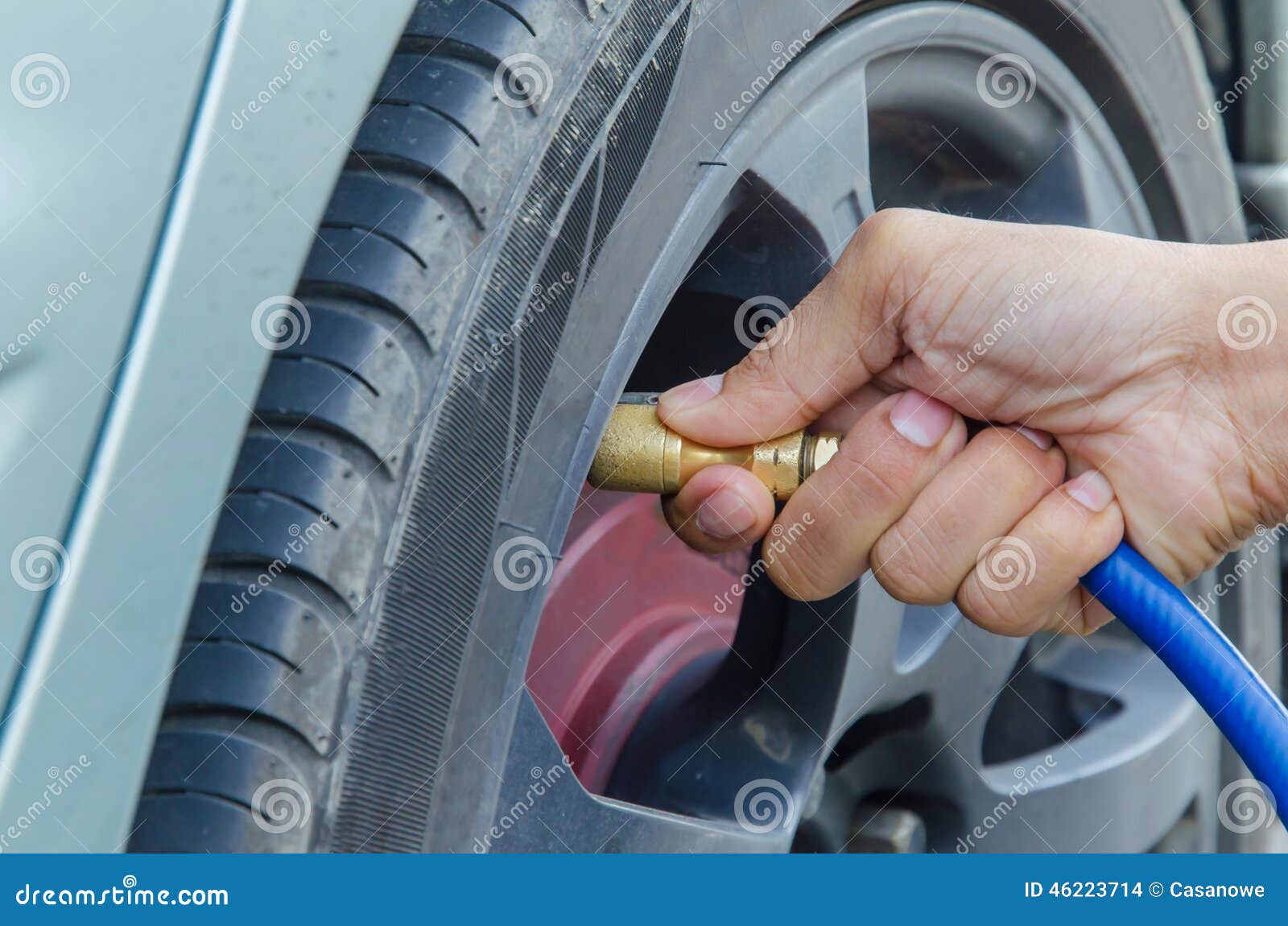 Filling Air into a Car Tire Stock Photo - Image of inflator, power ...