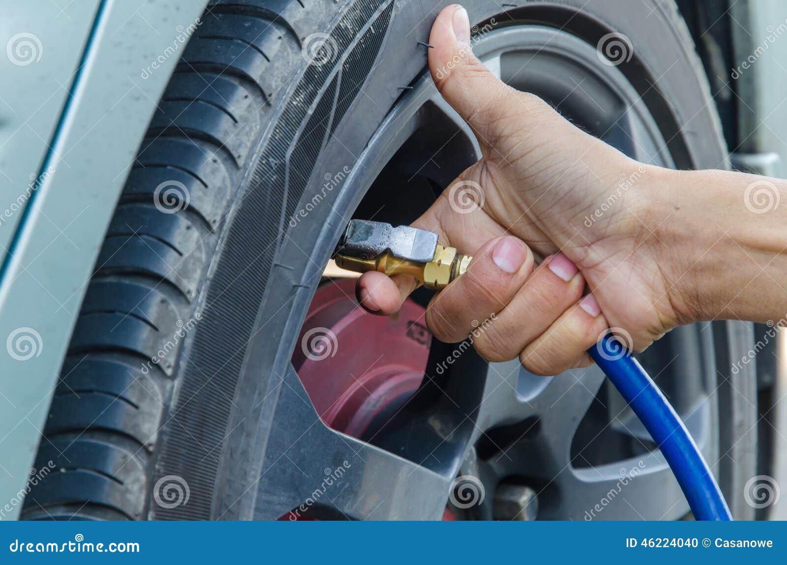 Filling Air into a Car Tire Stock Photo - Image of blue, inflator: 46224040