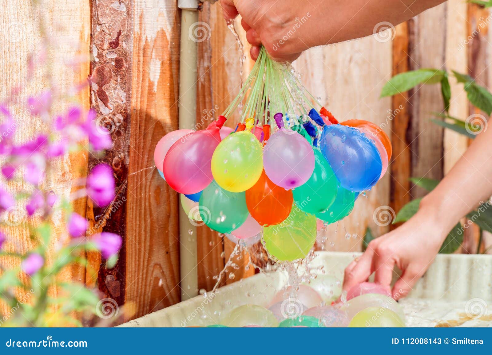 Filling Colorful Water Balloons Stock Image - Image of fight, adults ...