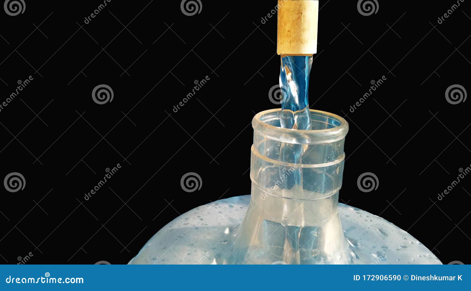 Filling Drinking Water in the Cane with the Black Background Stock ...