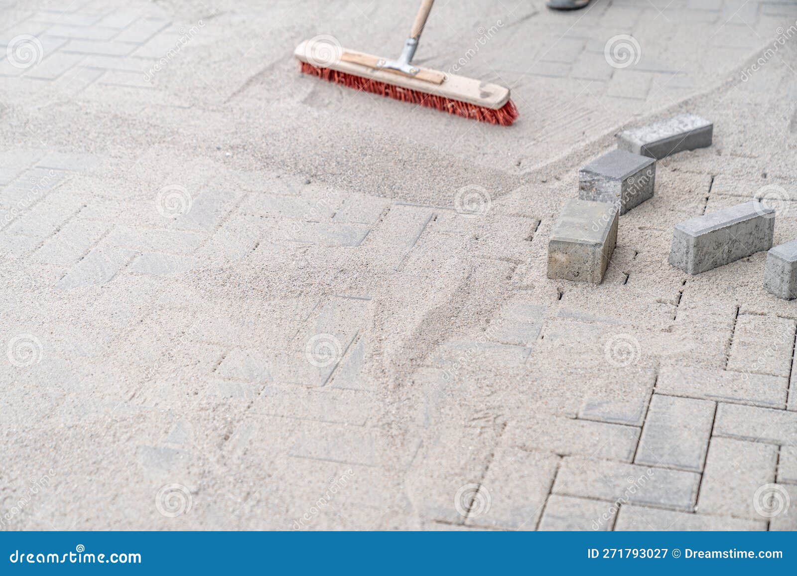 Sweeping Sand with a Broom during the Construction of a New Pavement ...
