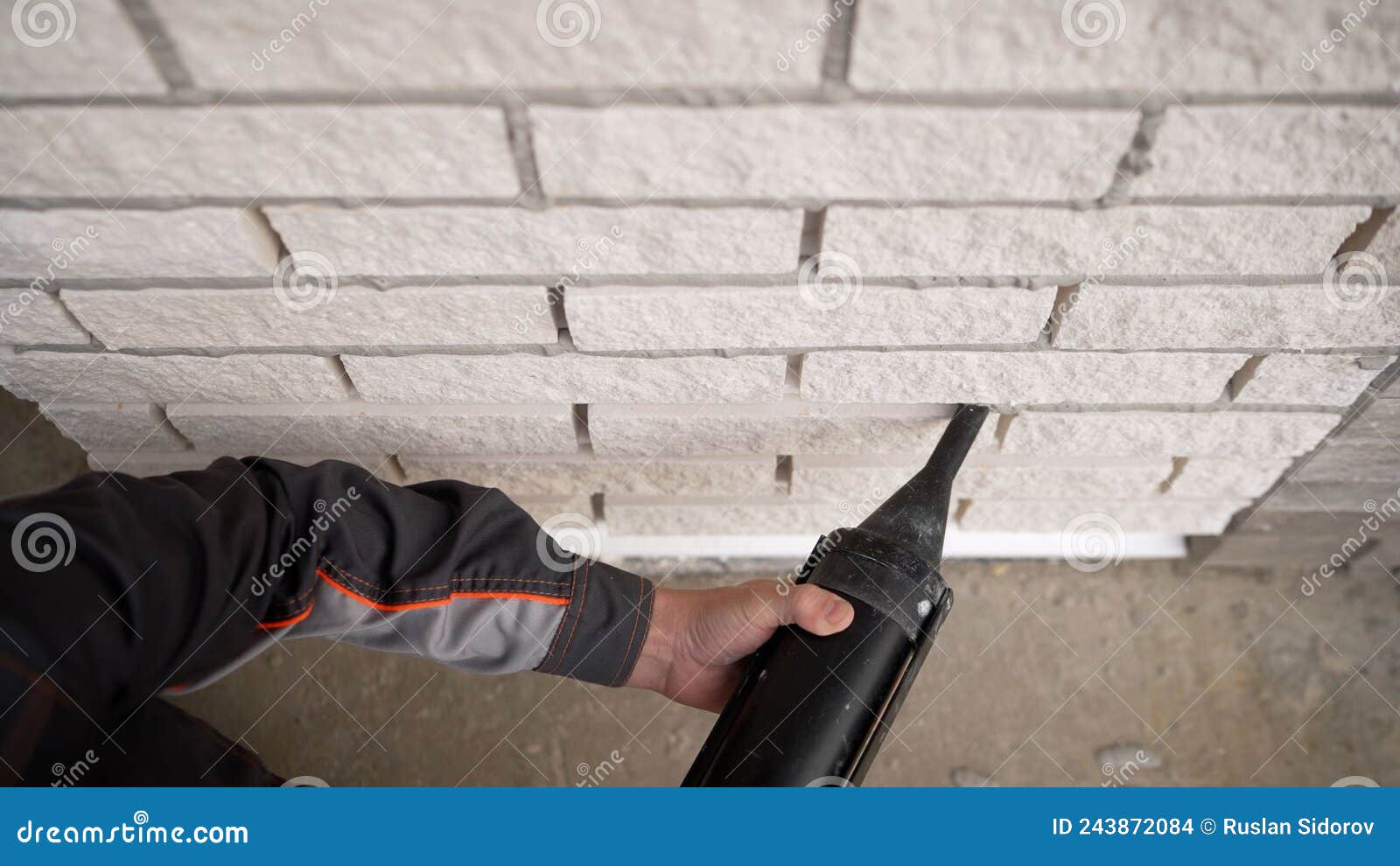 Filling the Joints between Bricks on the Facade of the House. Poor ...