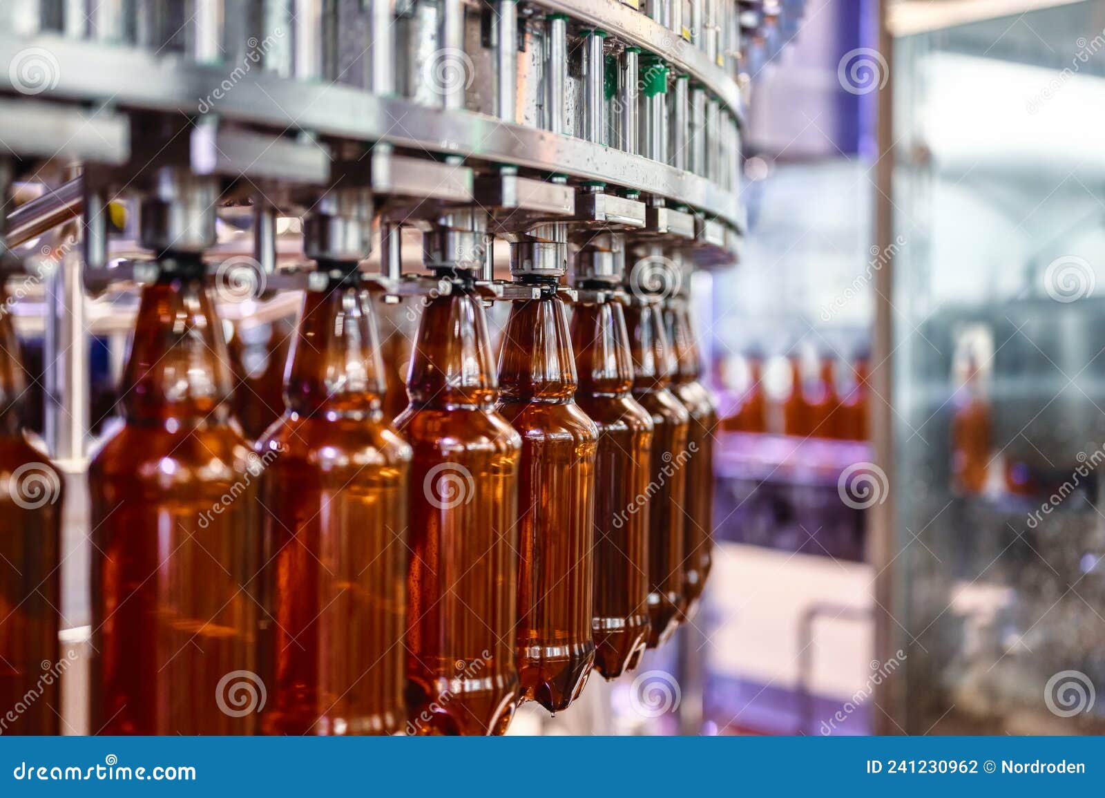 Filling Plastic Bottles with Various Drinks on an Automatic Filling ...