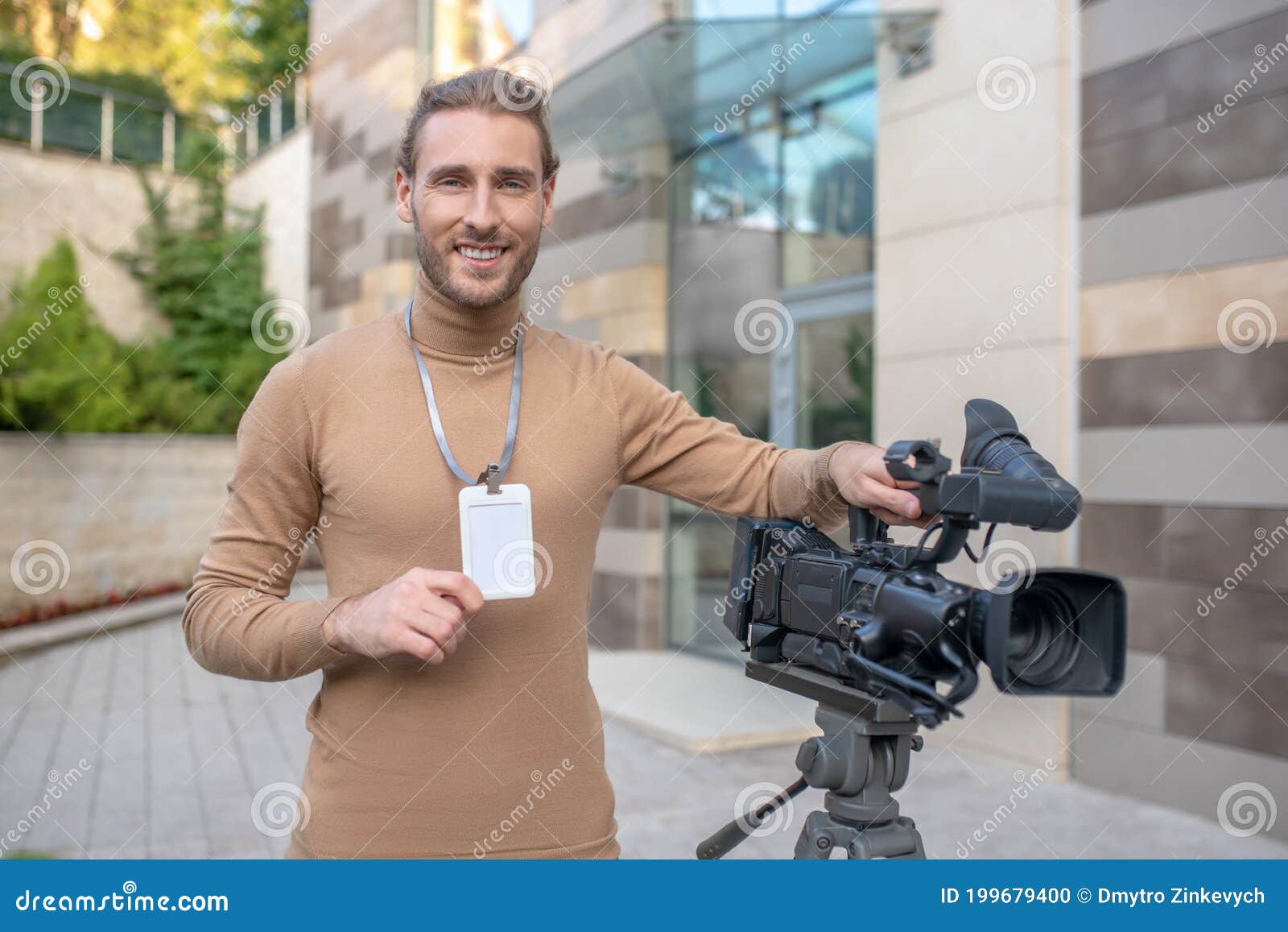 Smiling Operator Standing Near Camera in Front of Modern Building Stock ...