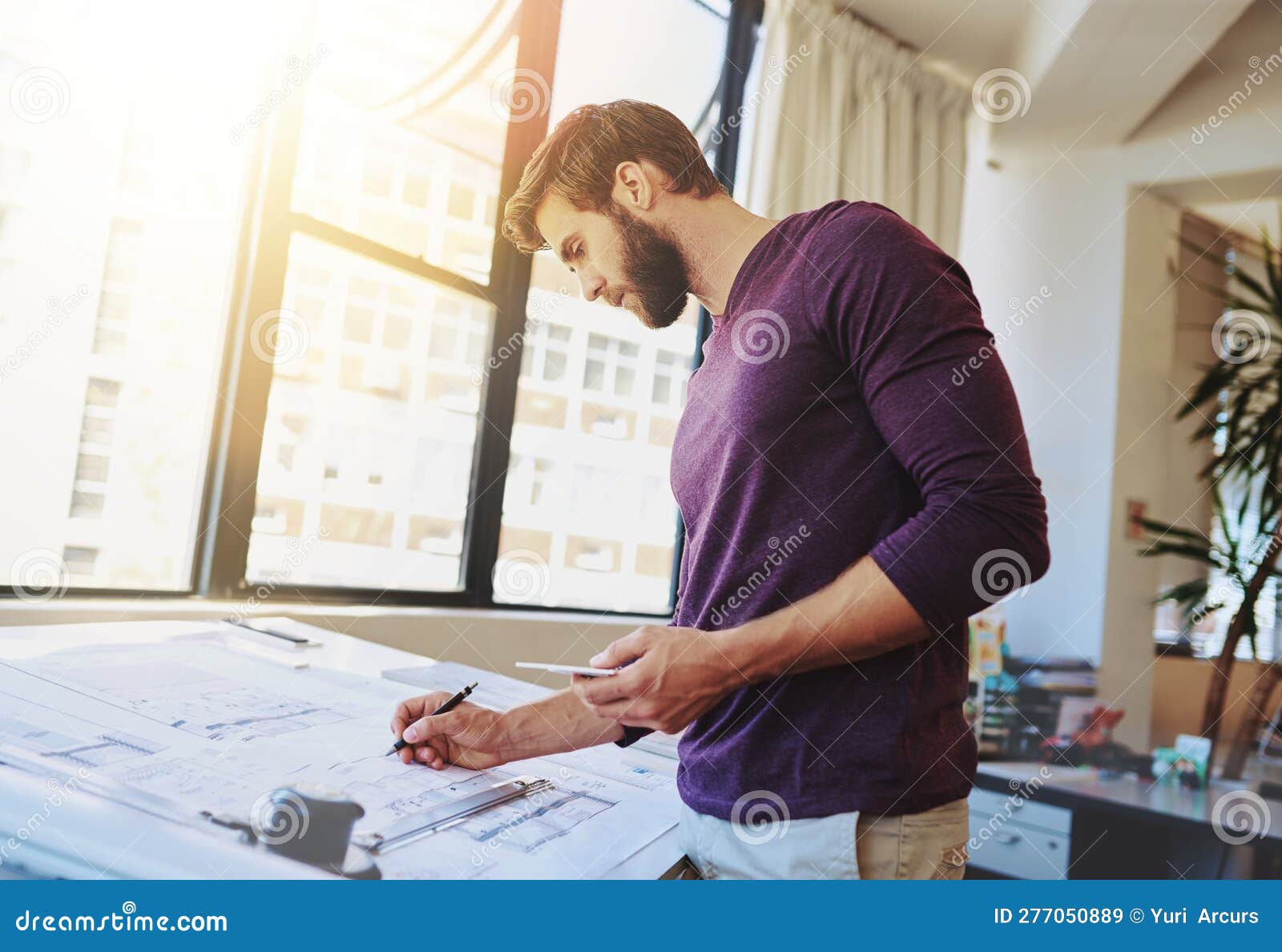 Finalizing the Plans. a Young Architect Working on His Drafting Table ...