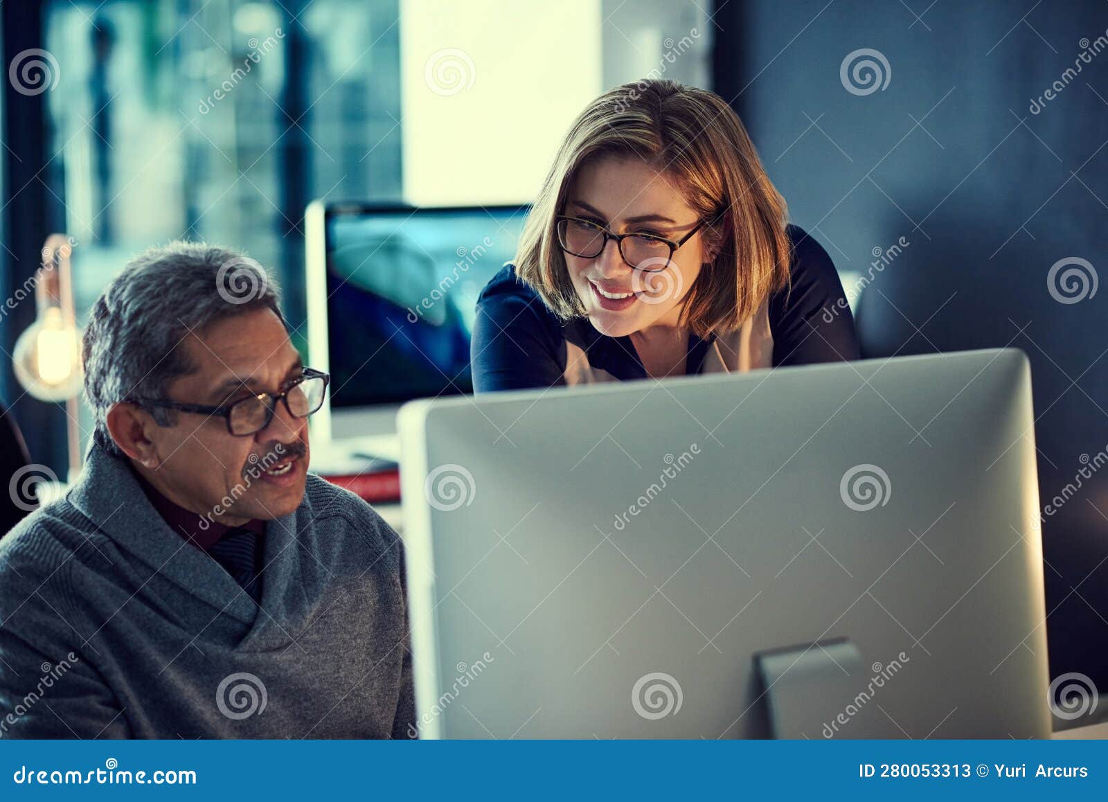 Finalizing Their Tasks. Two Businesspeople Working Late in an Office ...