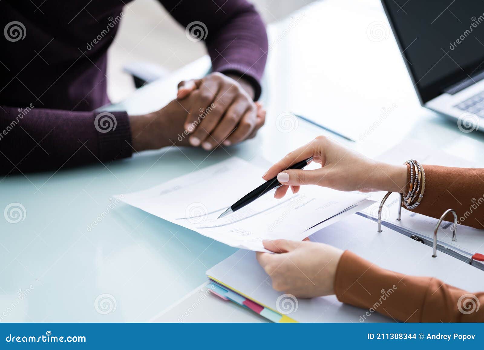 Financial Advisor Discussing Invoice with Her Client Stock Photo ...