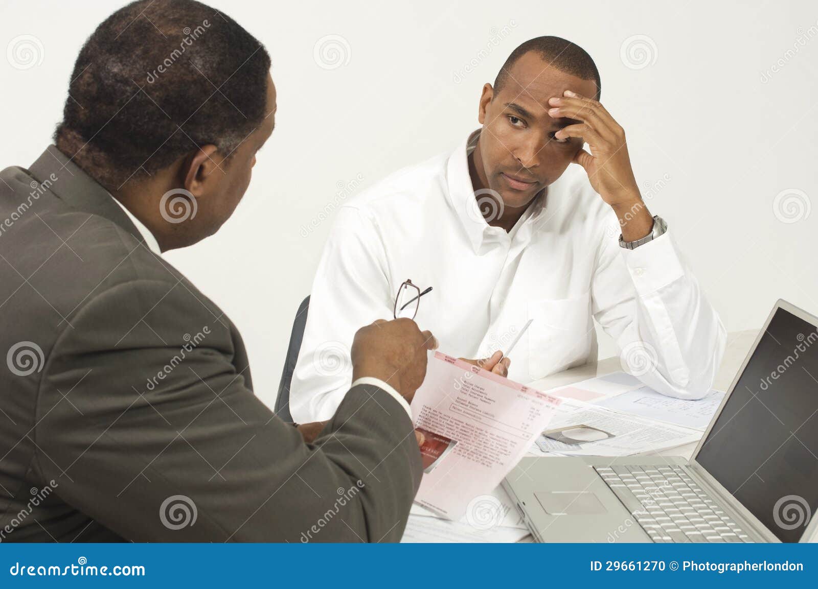 Financial Advisor in Discussion with Tensed Businessman Stock Photo ...