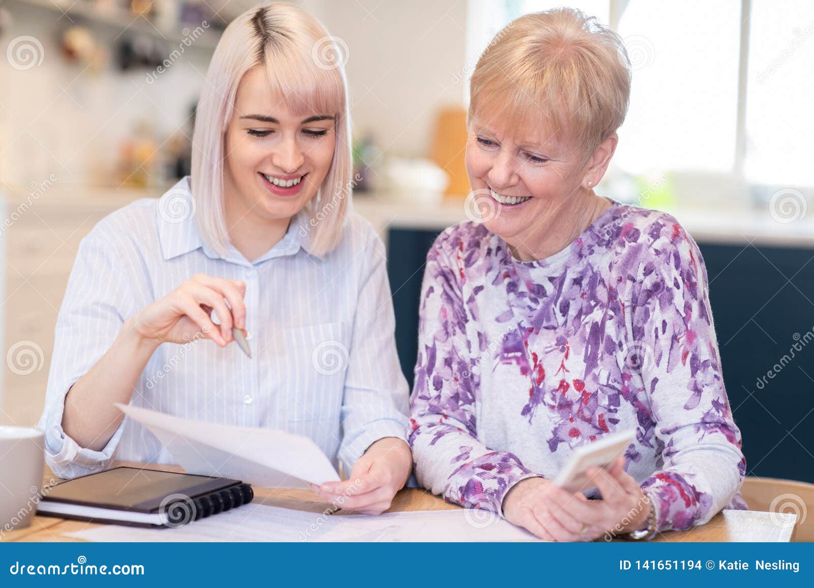 Financial Advisor Helping Senior Neighbor with Paperwork Stock Photo ...