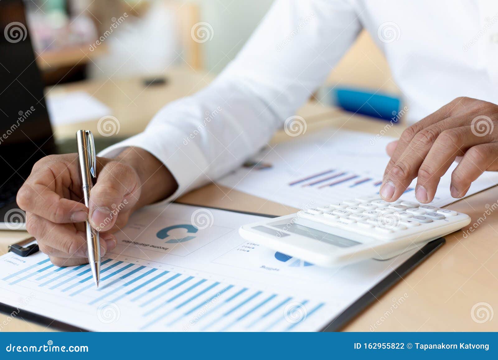 A Financial Businessman, a Young Man Analyzes Financial Data Using a ...